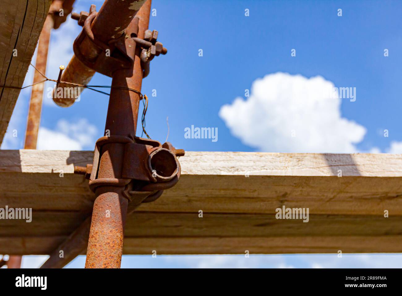 Joint of steel rusty scaffolding with tread, wooden plank for trampling ...