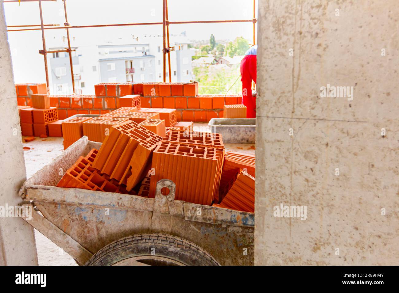 Heap of red blocks in Industrial obsolete wheelbarrow waiting to be ...