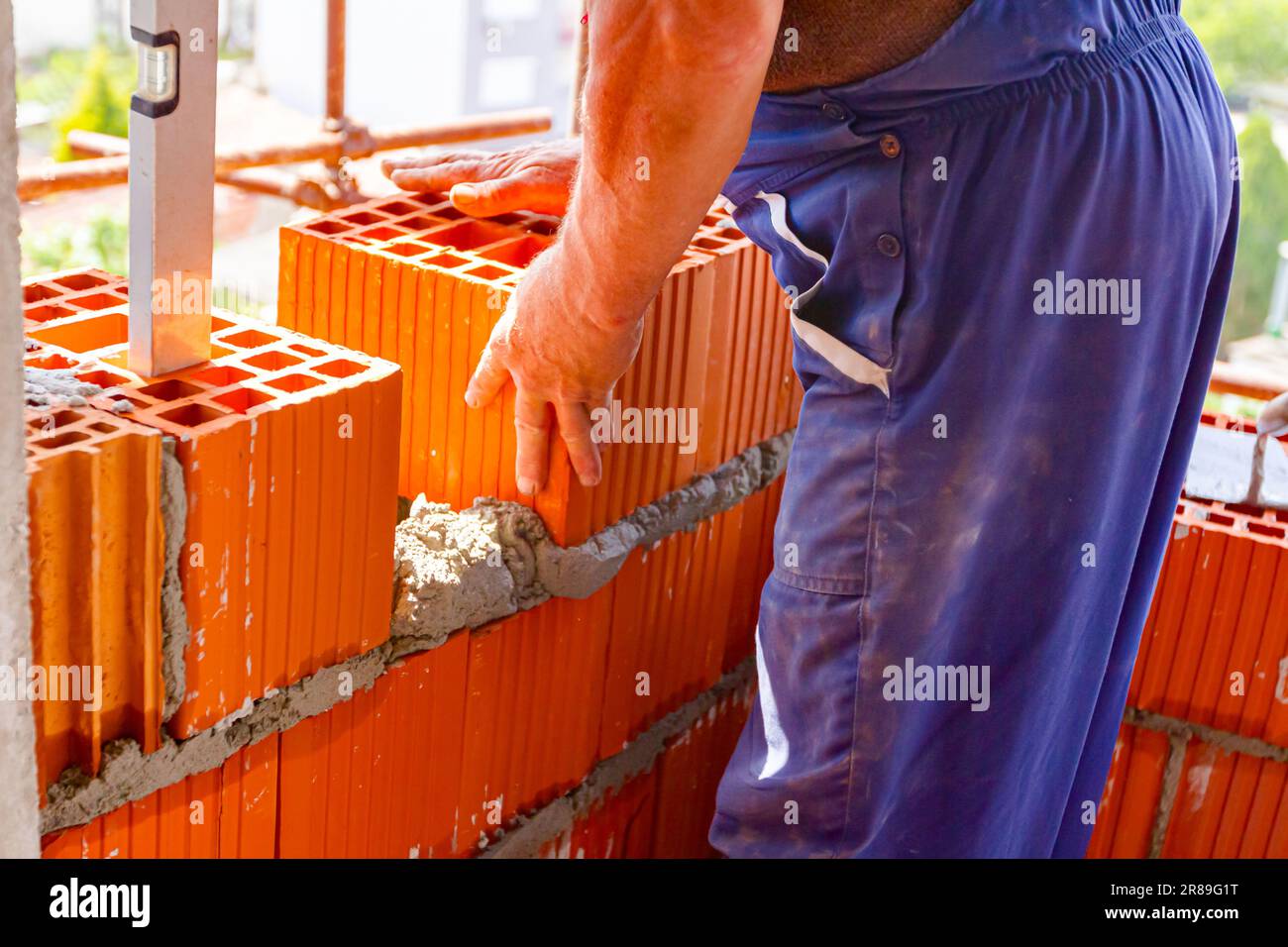 Spirit level for control measurement stuck in hollow of red ceramic ...