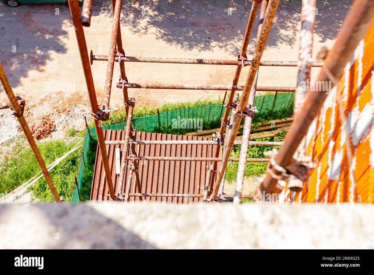 View on building site area from above trough rusty scaffolding. Edifice ...