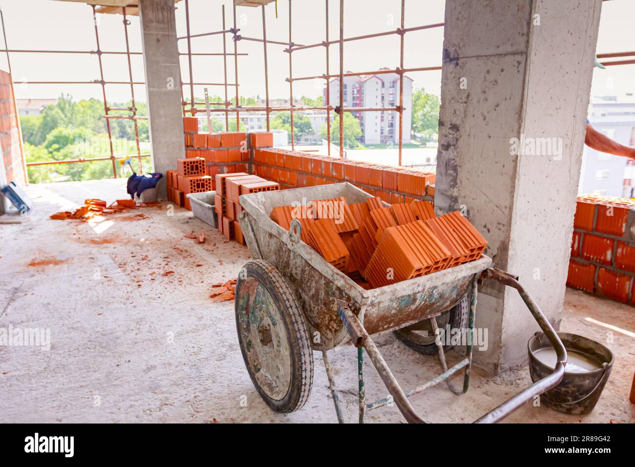 Heap of red blocks in Industrial obsolete wheelbarrow waiting to be ...