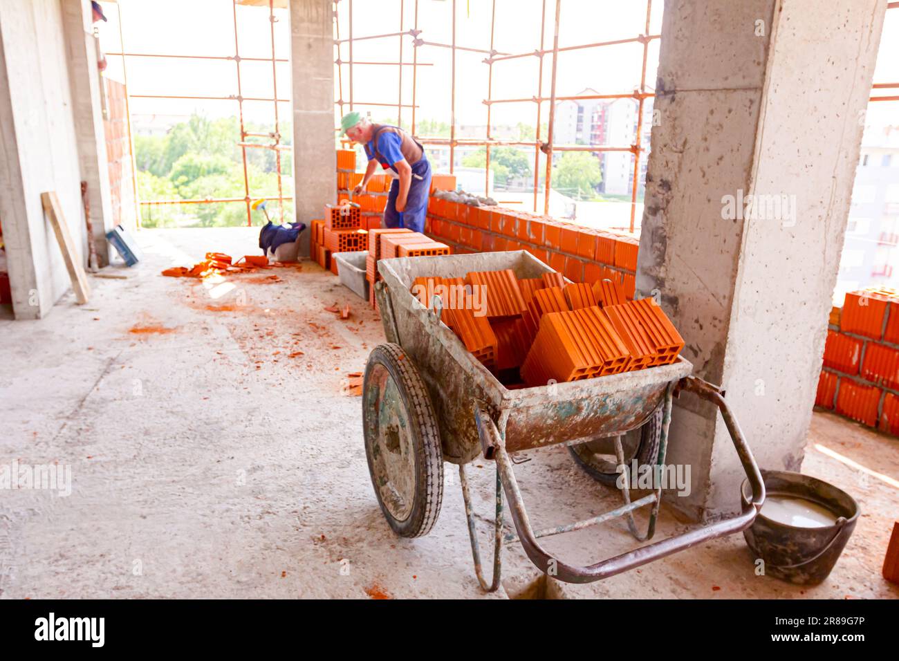 Heap of red blocks in Industrial obsolete wheelbarrow waiting to be ...