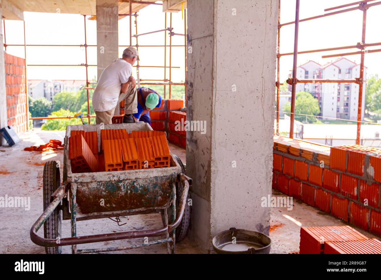 Heap of red blocks in Industrial obsolete wheelbarrow waiting to be ...