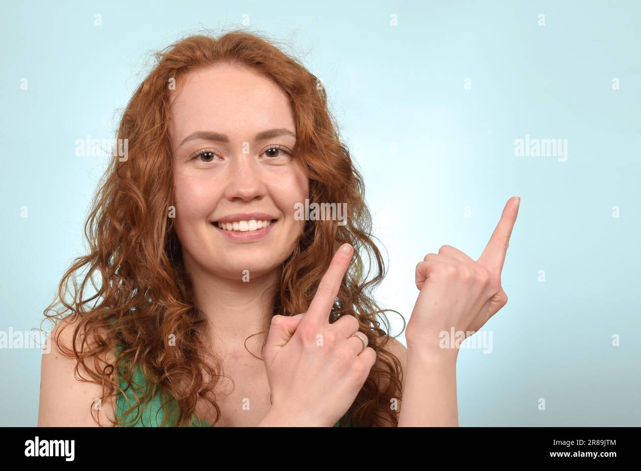 Pretty girl showing direction isolated hi-res stock photography and ...