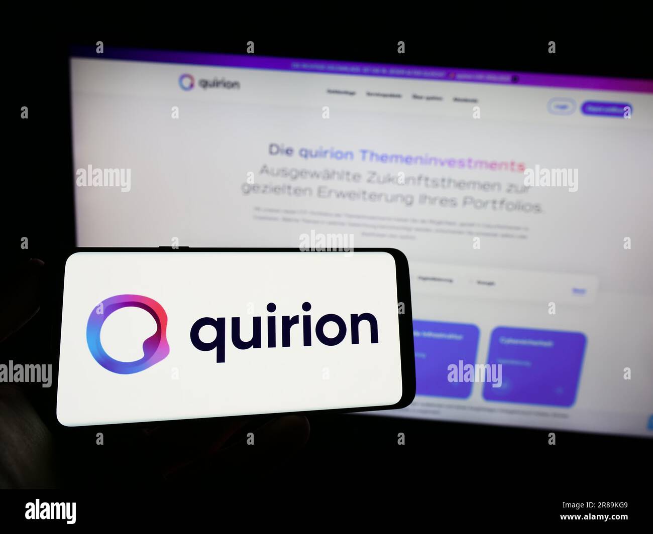 Person holding mobile phone with logo of German financial services ...