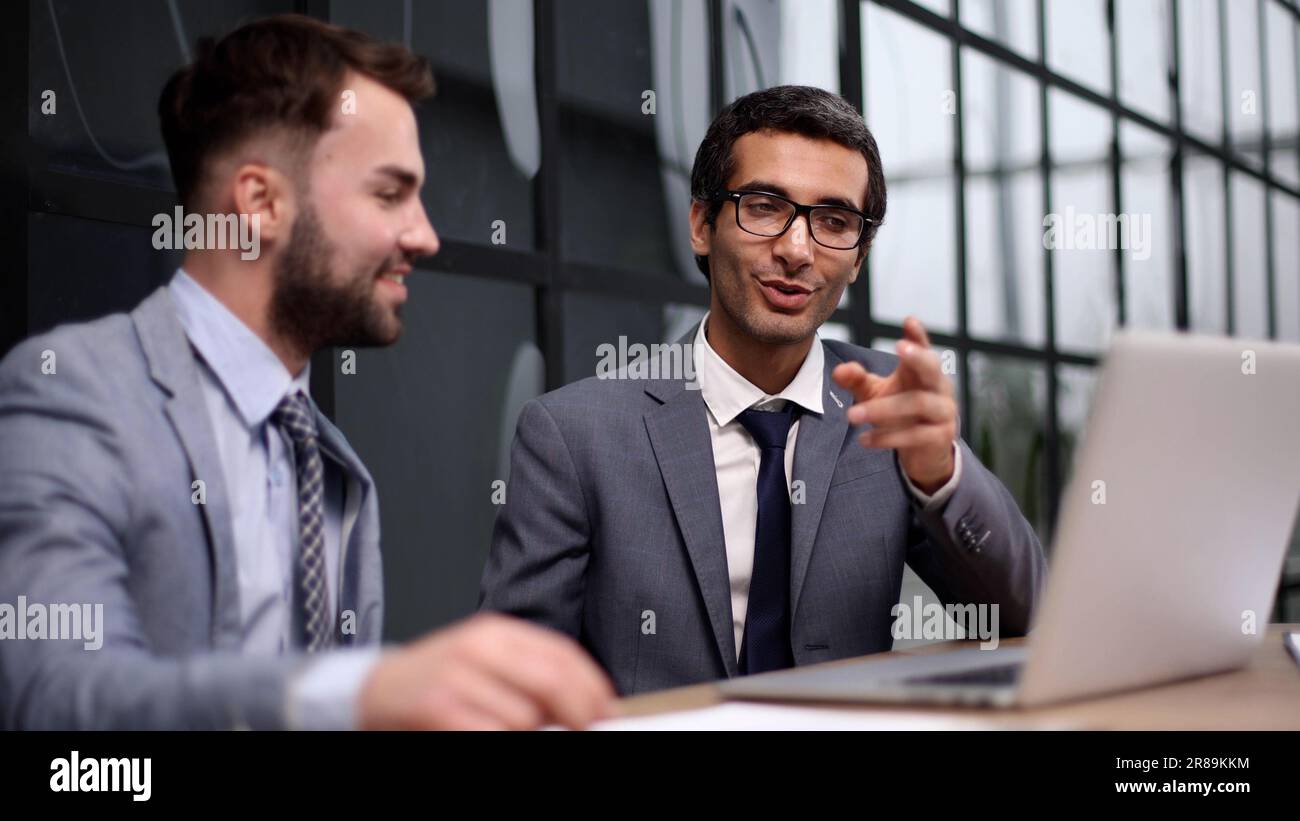 Young designer giving some new ideas about project to his partners in ...