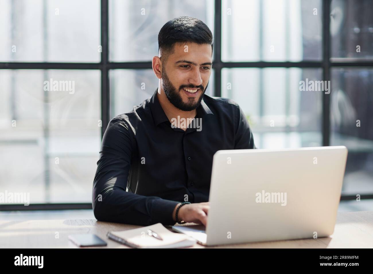 Bearded young businessman working on modern office. Consultant man ...