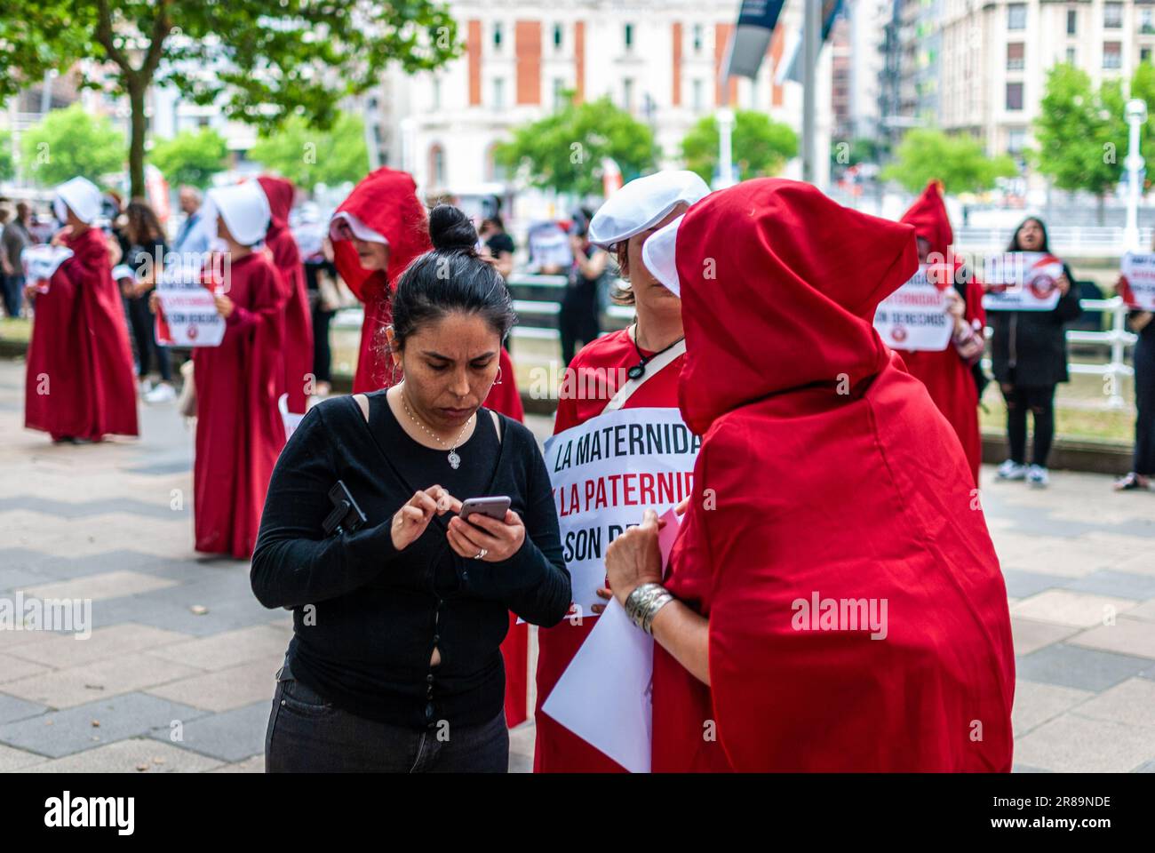 Radical feminist activists dressed in a costume from the series 'The ...