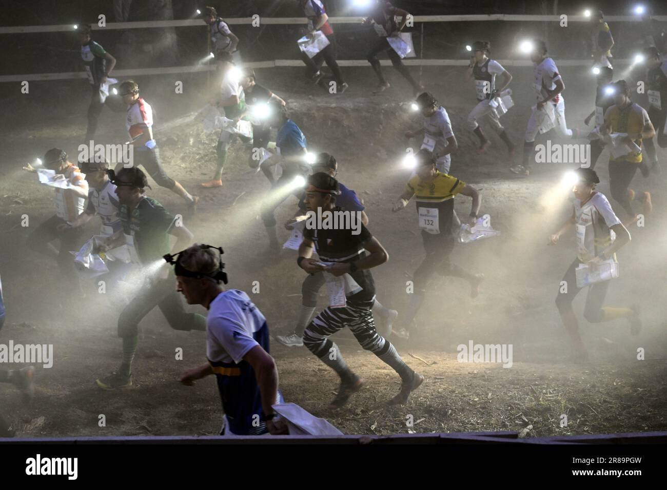 Headlamps illuminate while athletes start competing in the ...