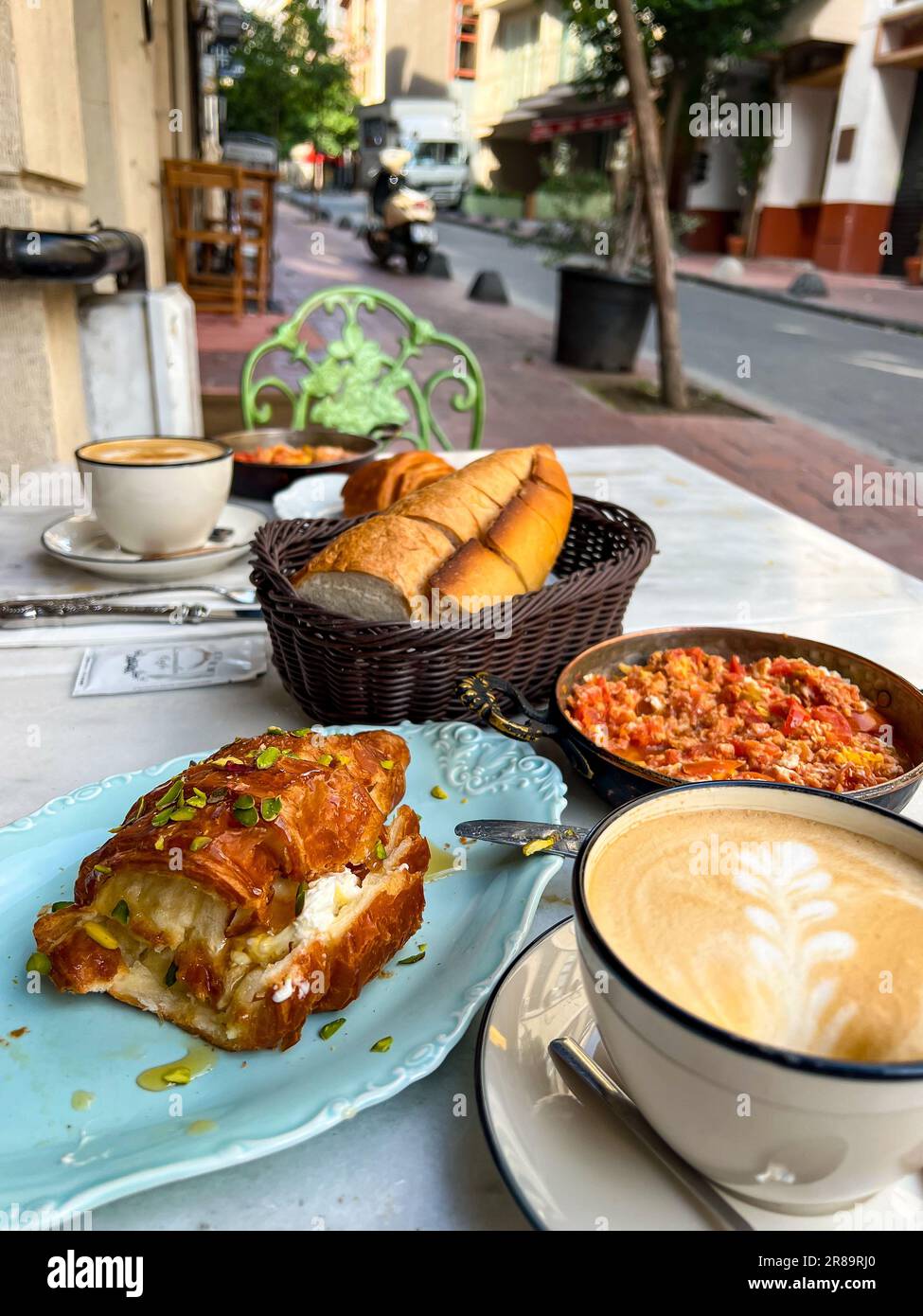 Turkish breakfast with menemen and kaymak croissant on a table of a ...