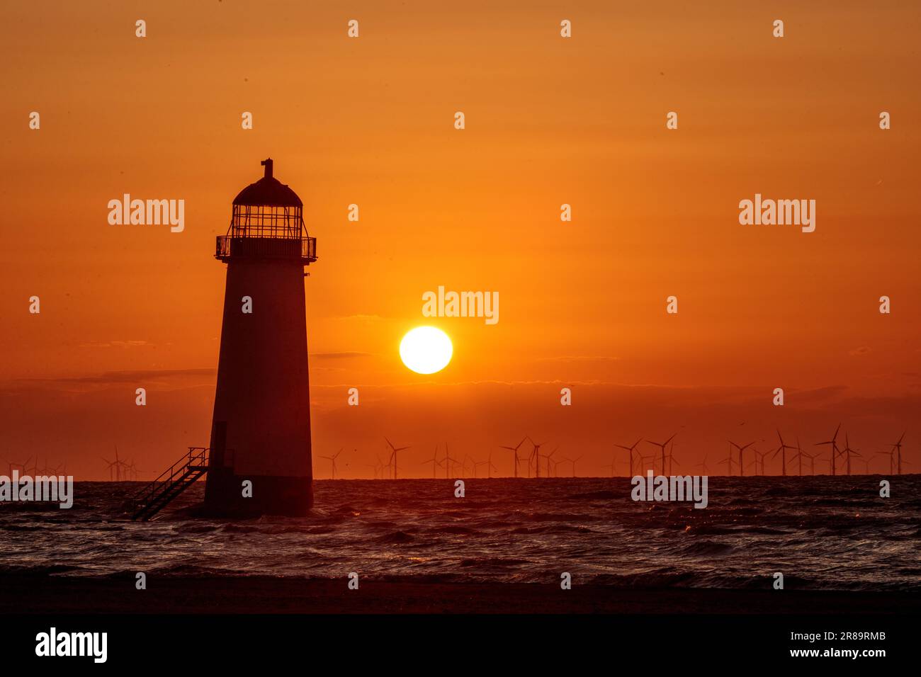 Sunset over Point of Ayr lighthouse, Talacre, North Wales Stock Photo ...
