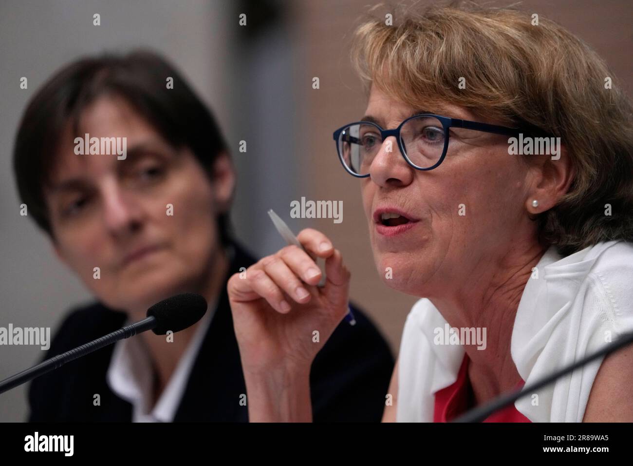 Helena Jeppesen Spuhler, right, delivers her speech with sister Nadia ...