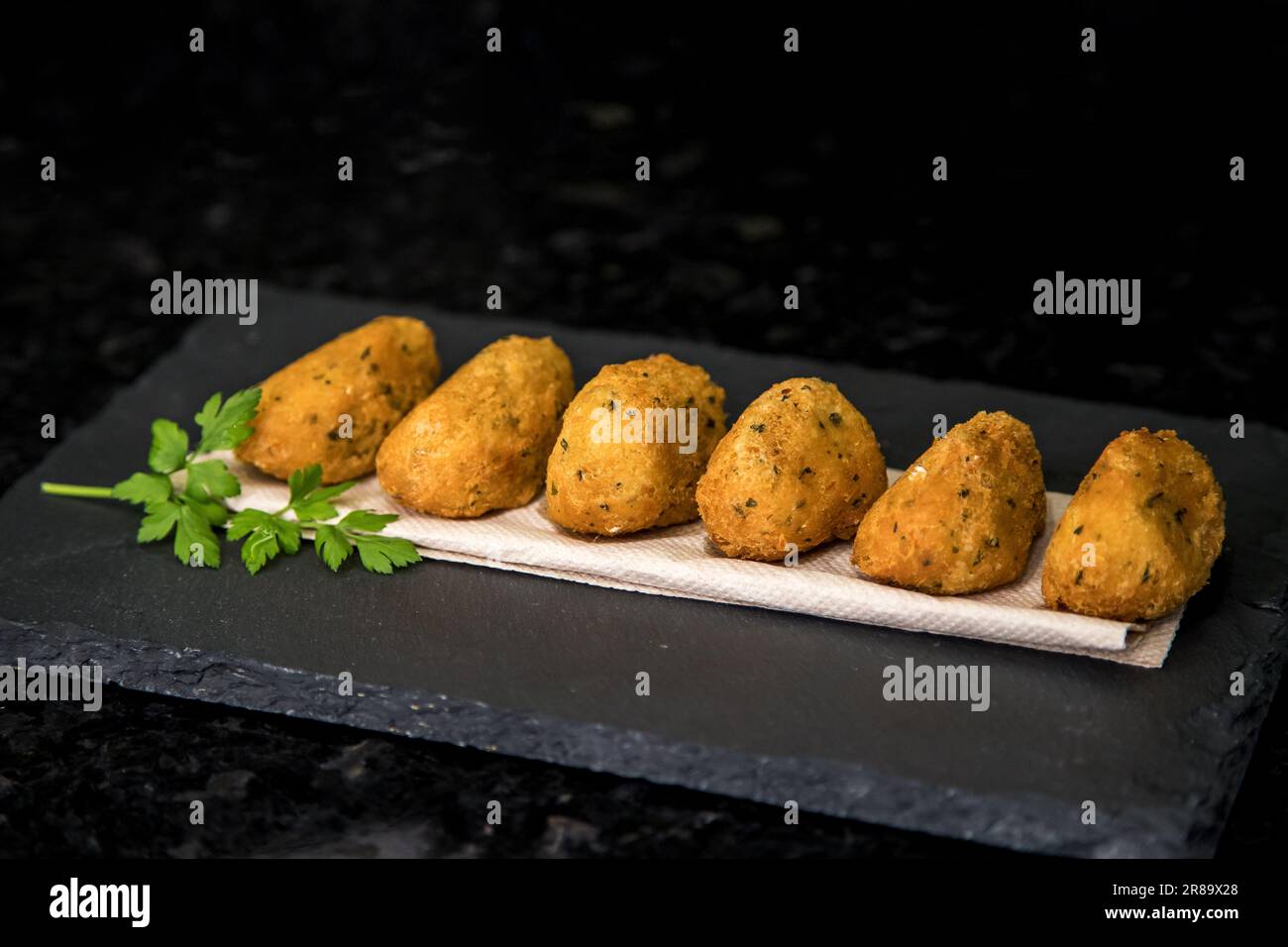 Bolinhos de bacalhau, very famous in Portuguese gastronomy. Fried ...