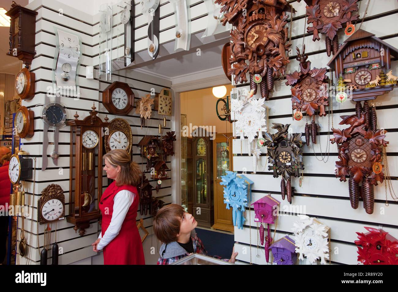 Netherlands, Velp. Boy in a shop full with analog clocks Stock Photo ...