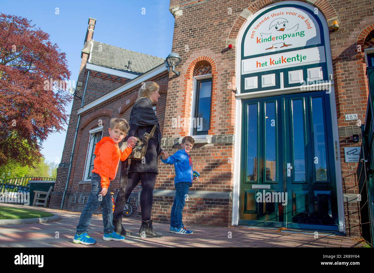 Netherlands, mother brings her children to daycare Stock Photo - Alamy