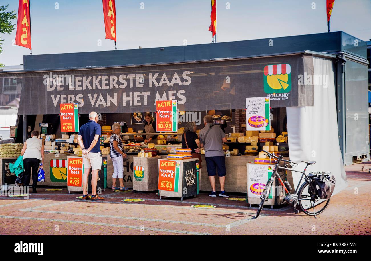 Netherlands, cheese is sold in a market stall or a booth. This is a ...