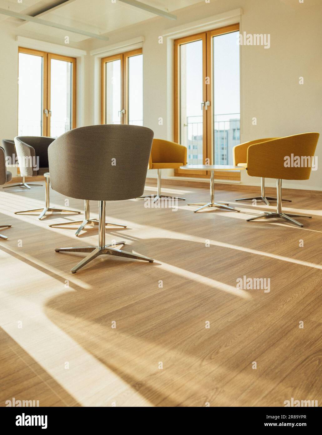 The chairs and tables around a modern office space near the windows ...