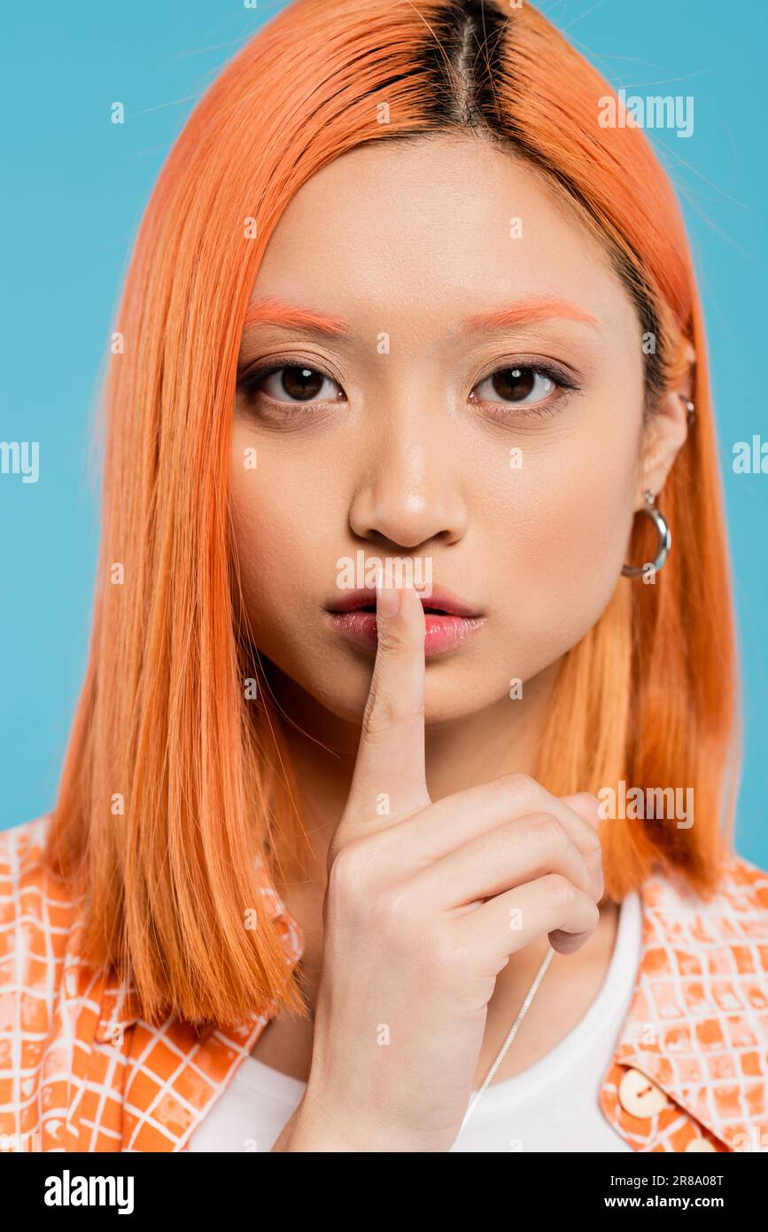 hush, young asian woman with dyed hair and eyebrows showing shh ...