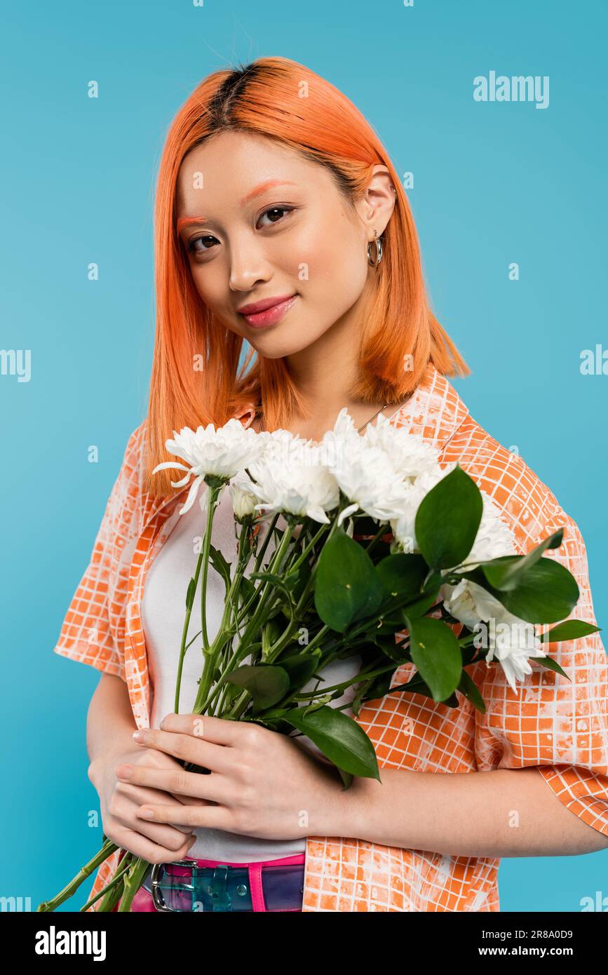 sensuality, cheerful asian woman with red hair holding white flowers on ...