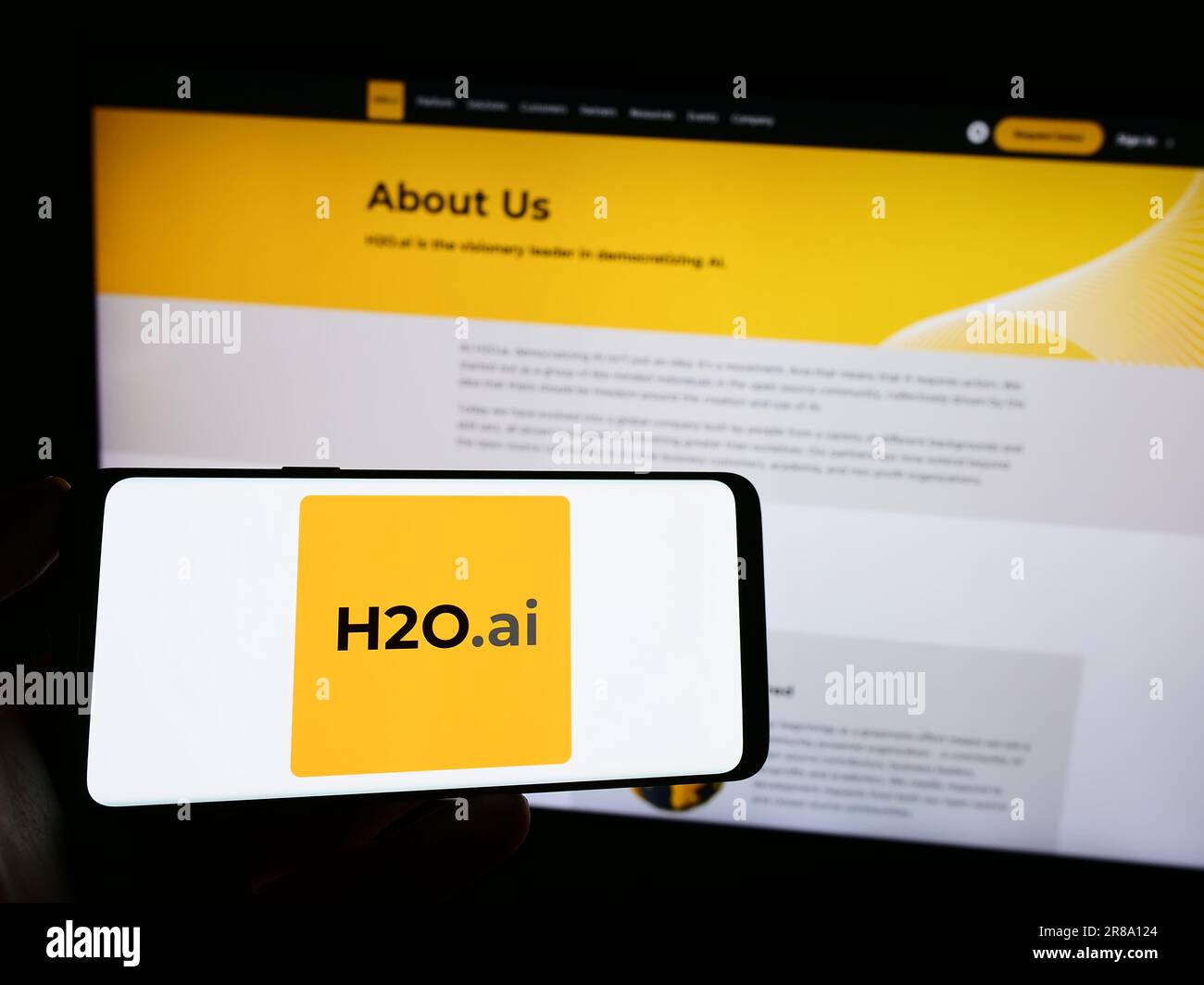 Person holding mobile phone with logo of US artificial intelligence ...