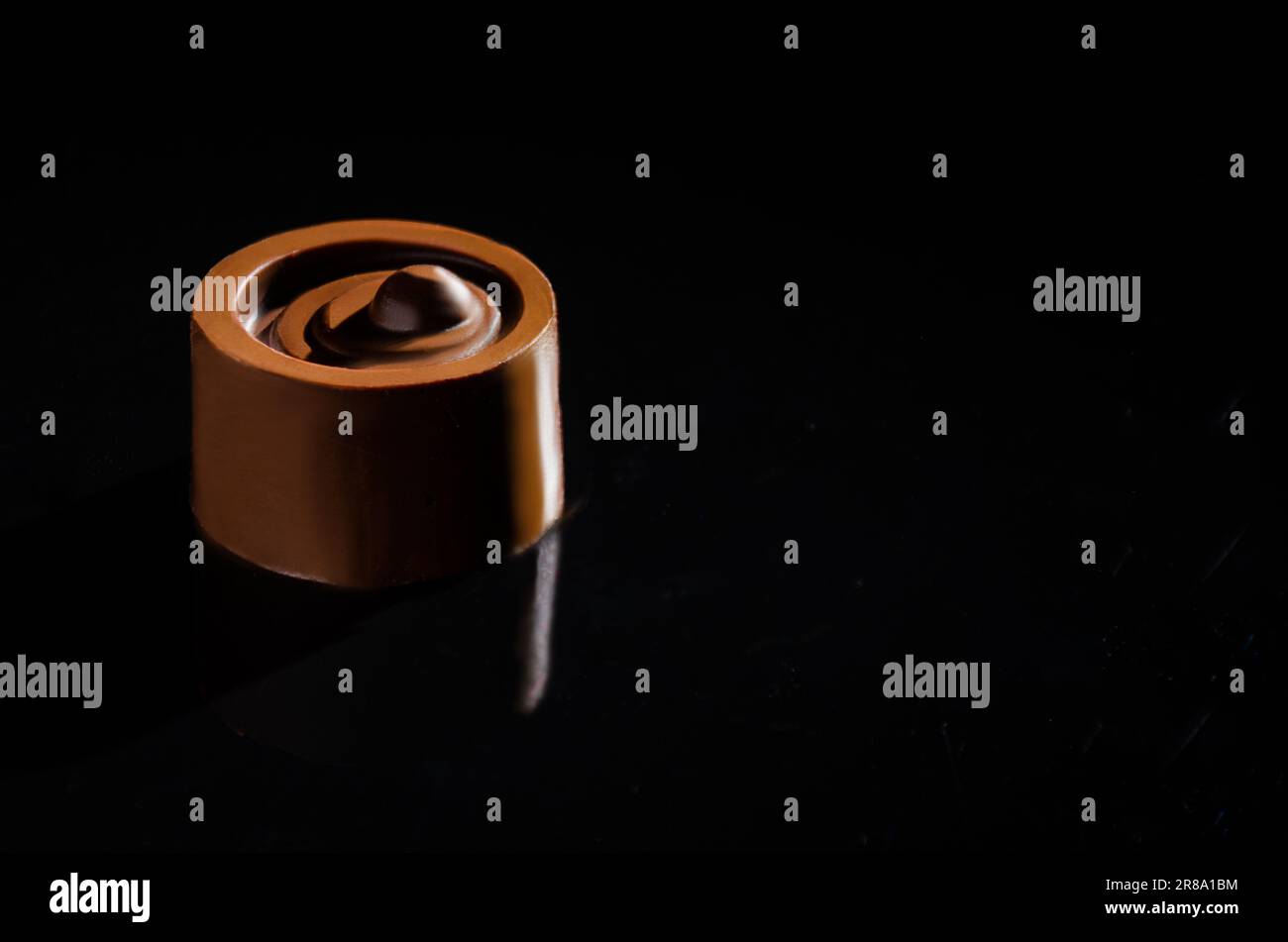 Chocolate bonbon in a circular shape. plain black background Stock ...