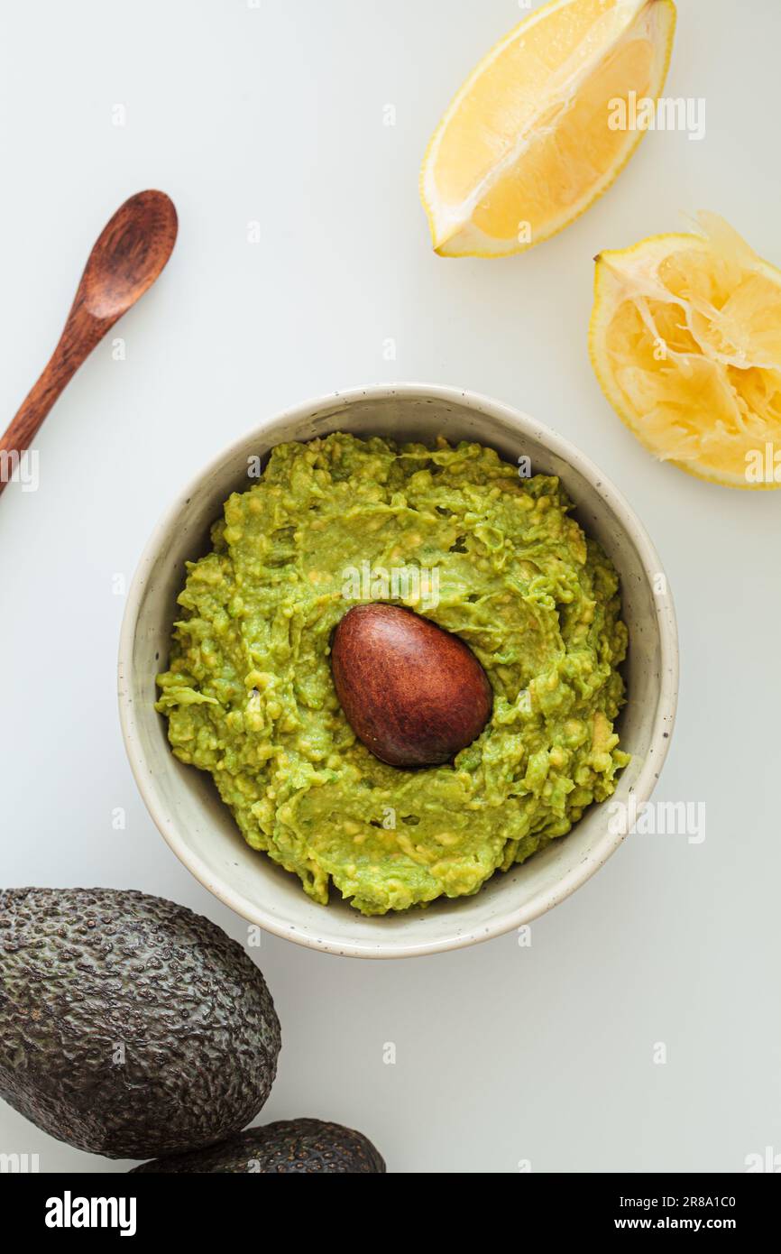 Guacamole with bone in a white bowl, white background, top view ...