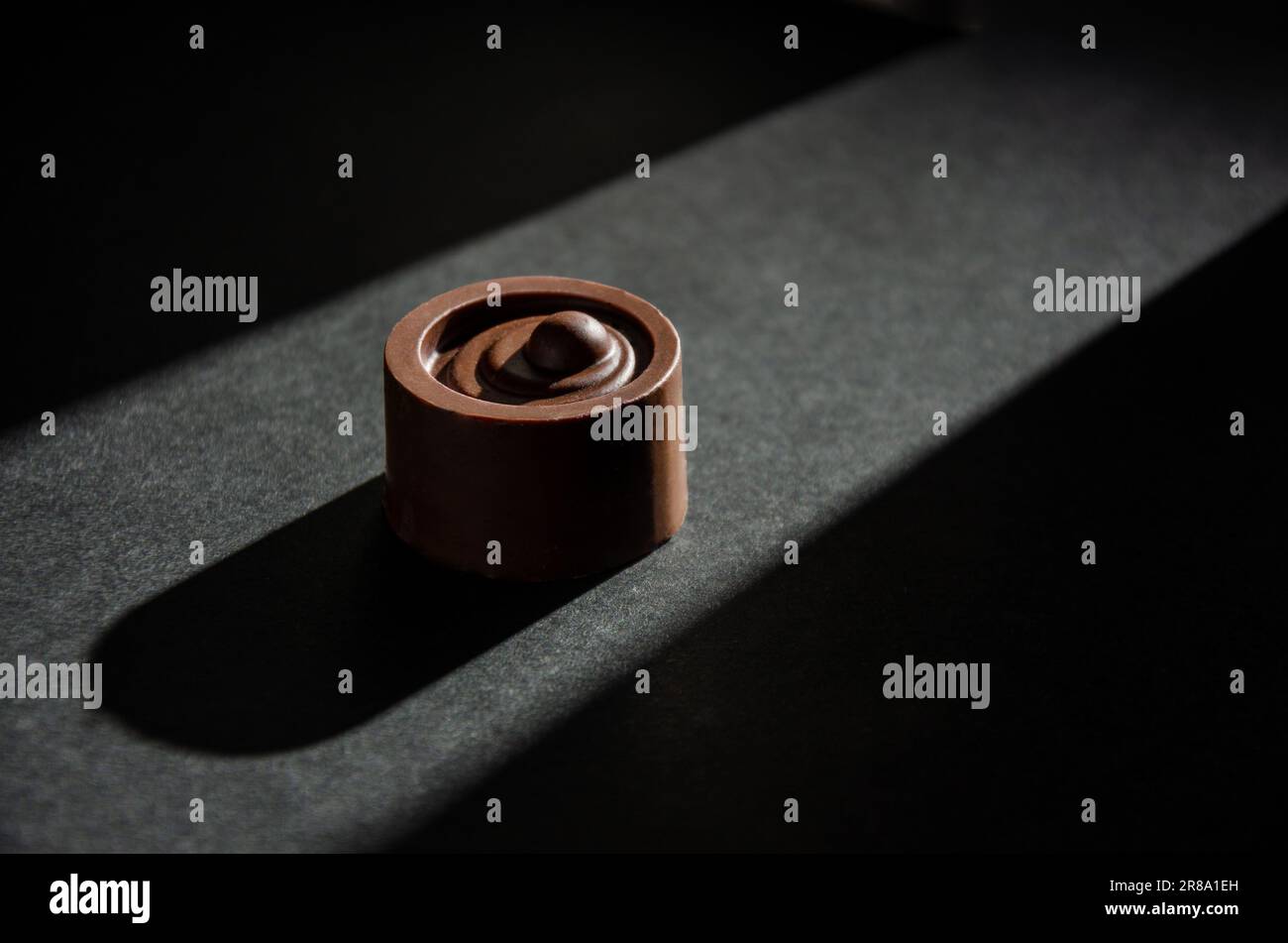 Chocolate bonbon in a circular shape. plain black background Stock ...