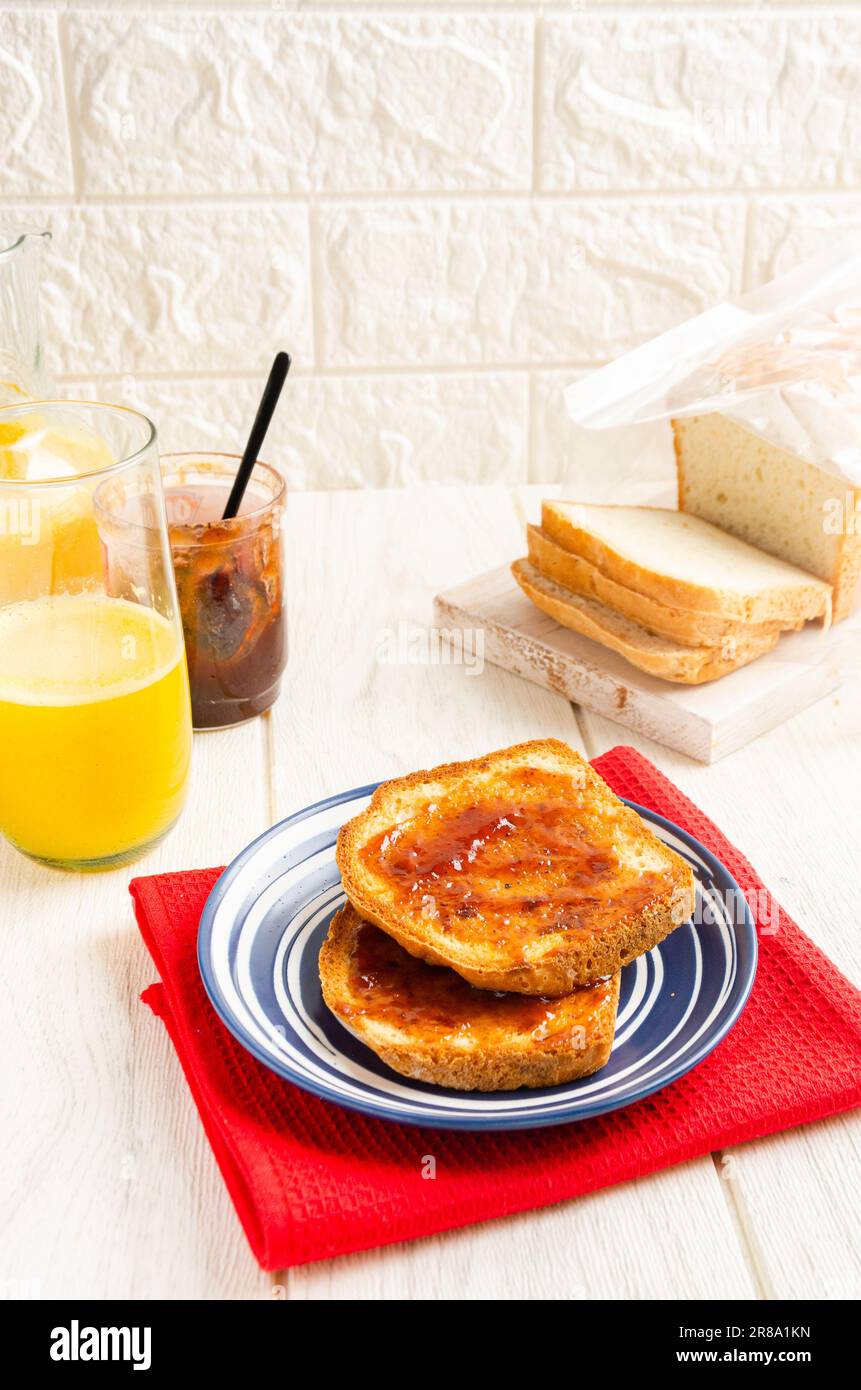 Toast with jam and orange juice. White background Stock Photo - Alamy