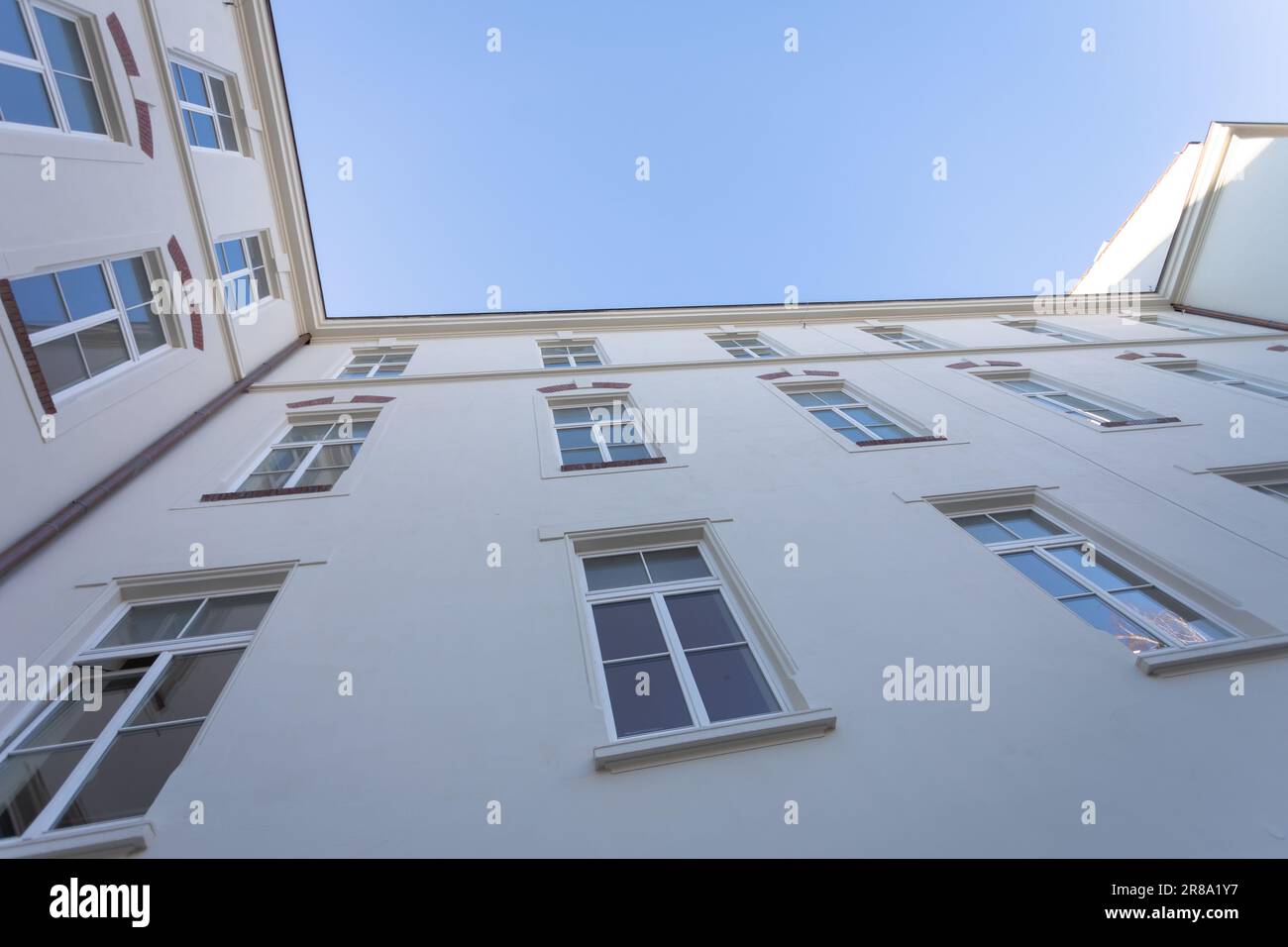 The smooth wall of the building with large windows seen from the very ...