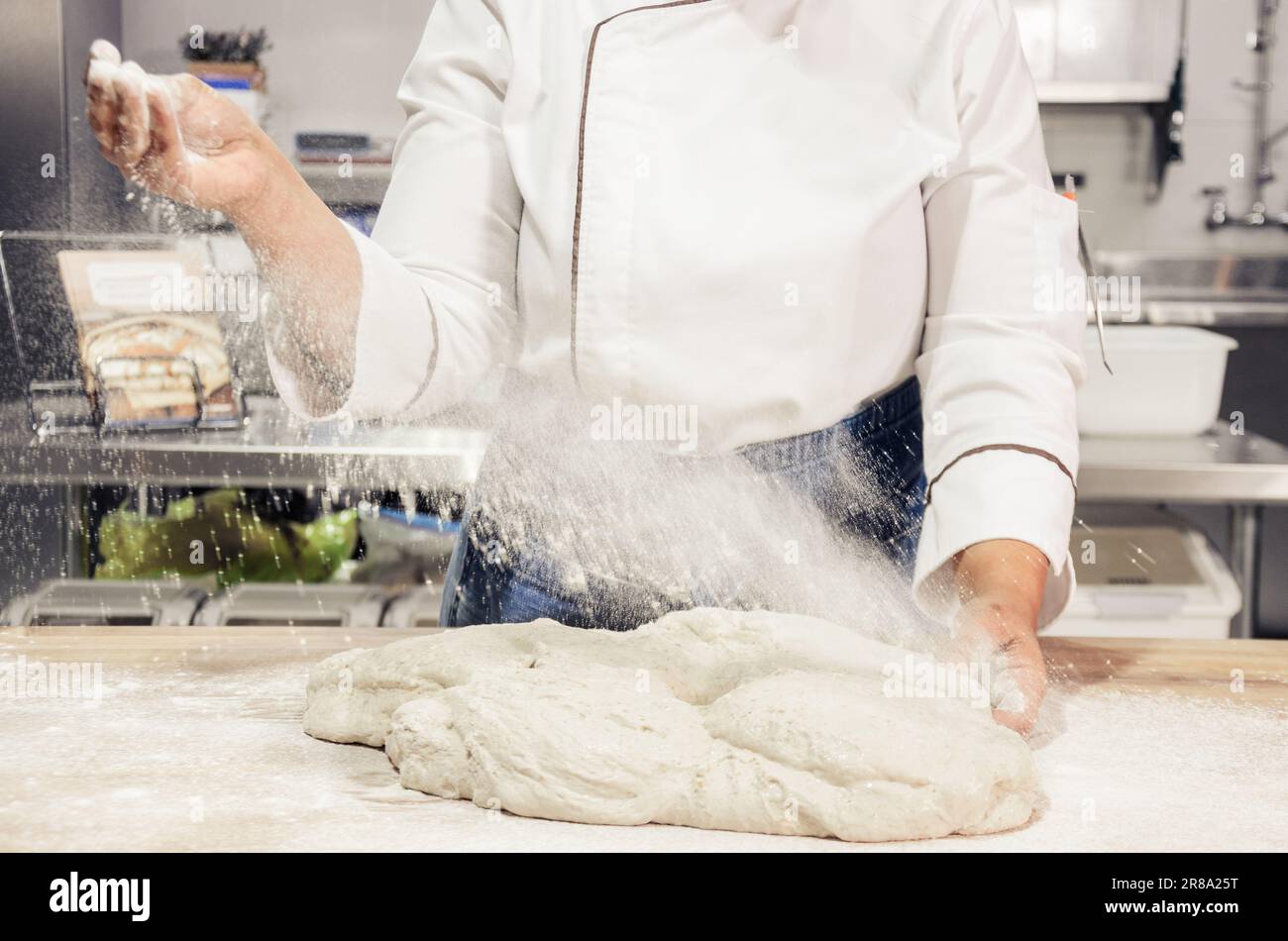 Kneading and preparation of sourdough-based bread. On a wooden table ...