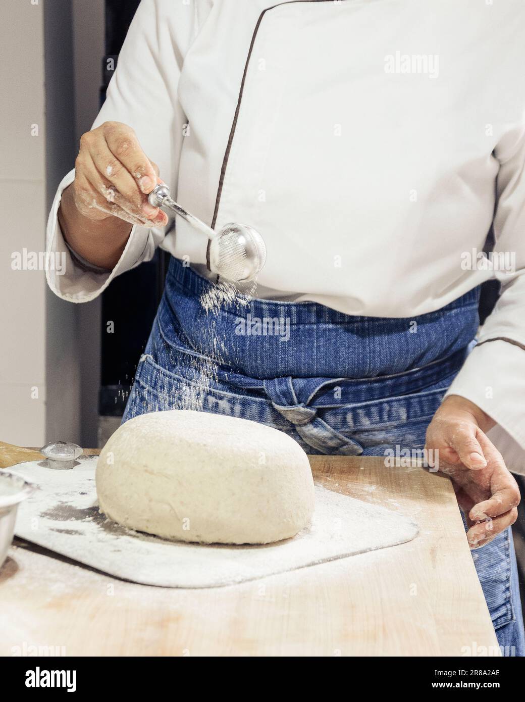 Kneading and preparation of sourdough-based bread. On a wooden table ...