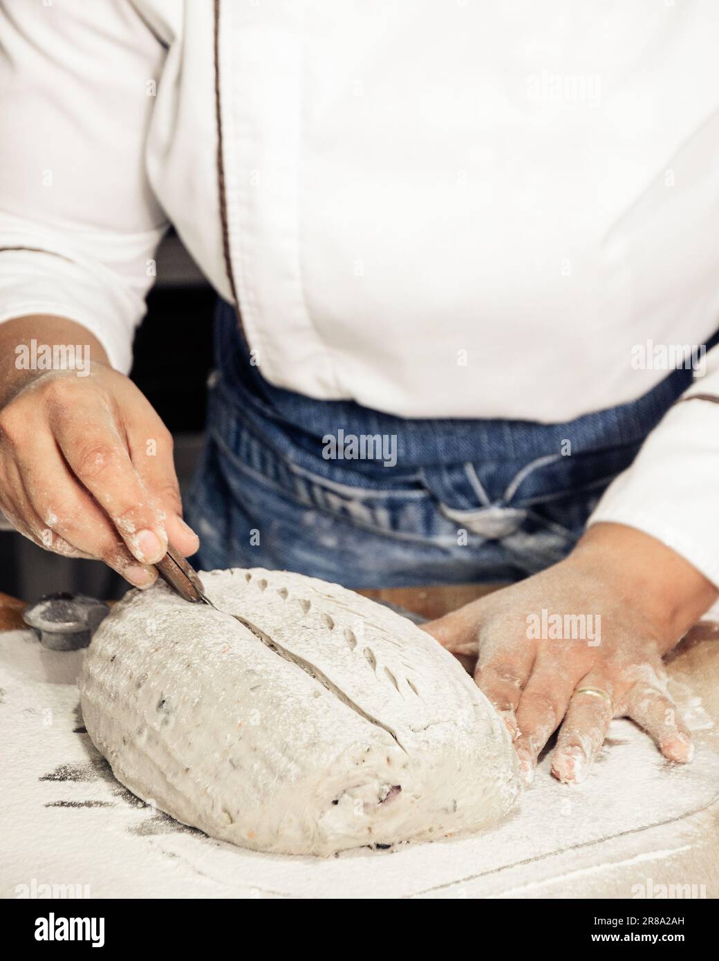 Kneading and preparation of sourdough-based bread. On a wooden table ...