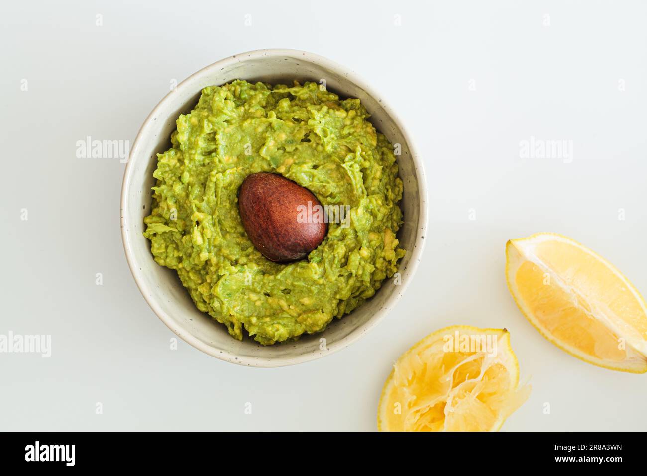 Guacamole with bone in a white bowl, white background, top view ...