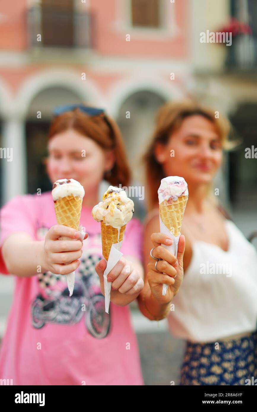 girls enjoying ice cream in a cone with ice cream balls. High quality ...