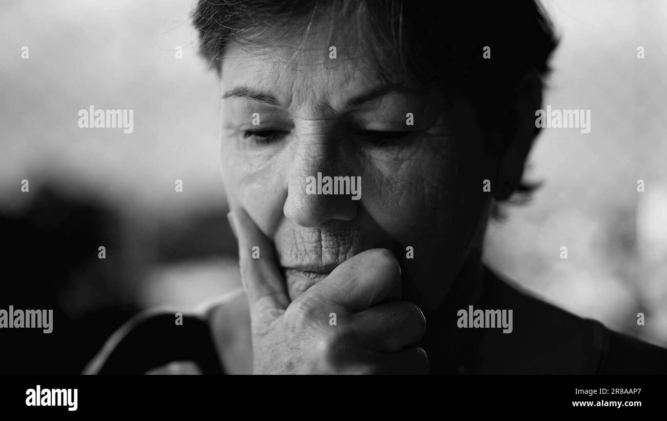 Thoughtful Senior Woman in Monochrome, Hand on Chin Stock Photo - Alamy