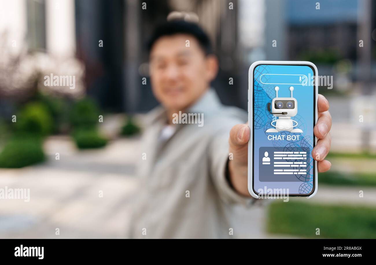 Phone with chat bot on screen in asian man hand Stock Photo - Alamy