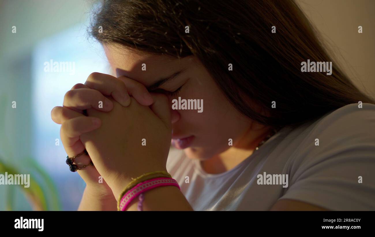 Catholic South American Woman Praying Intensely at Home, Clenched Hands ...