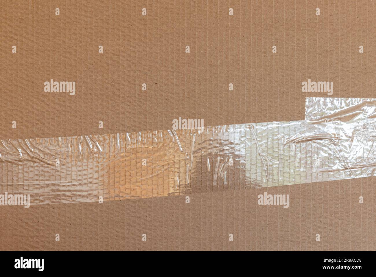 Pressure-sensitive tape is on a cardboard, front view. Close-up ...