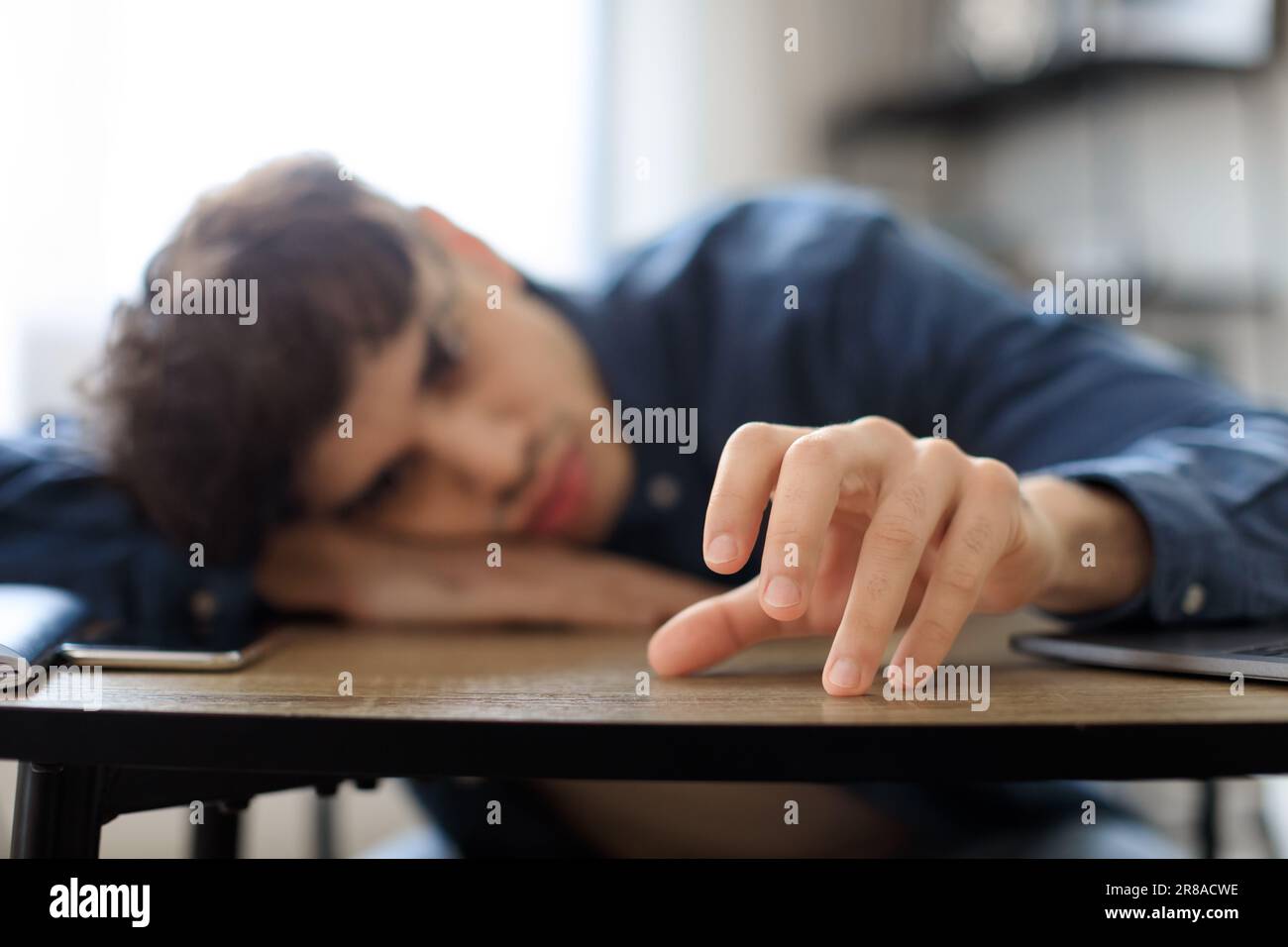 Man resting head on table hi-res stock photography and images - Alamy