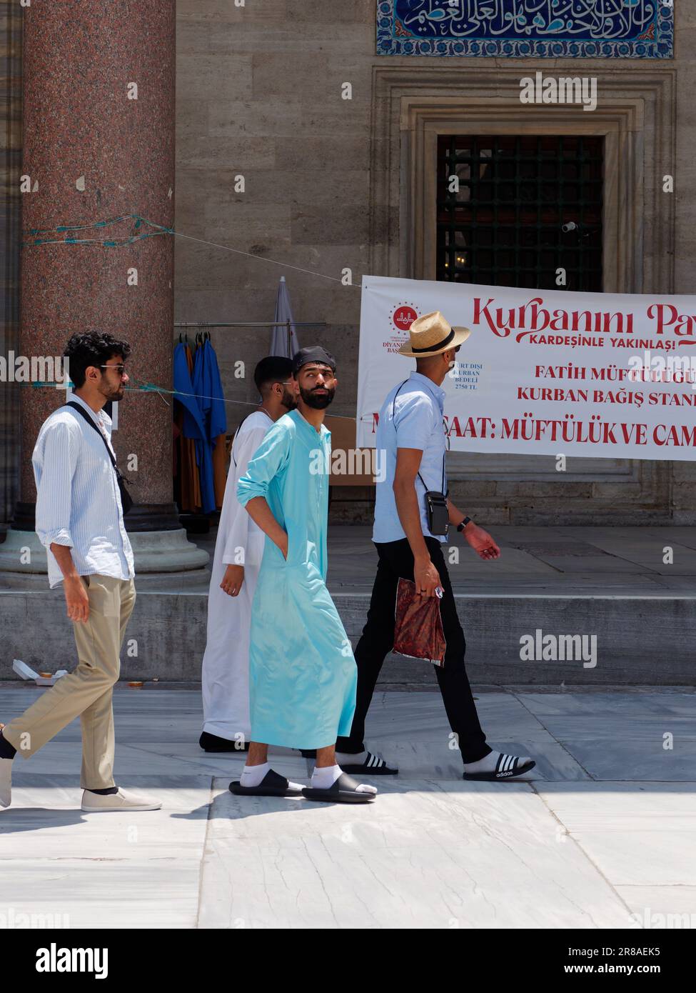 Muslim men walking in the courtyard aka sahn of the Suleymaniye Mosque ...