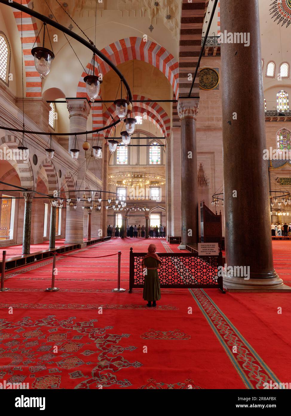 Inside the Suleymaniye Mosque in Istanbul, Turkey. A young girl in ...
