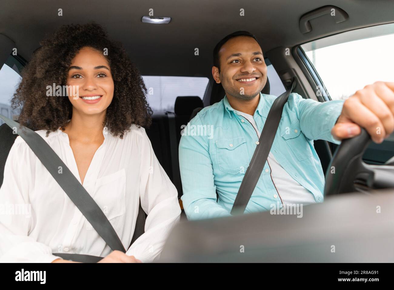Cheerful Middle Eastern Couple Having Car Trip Sitting In Automobile