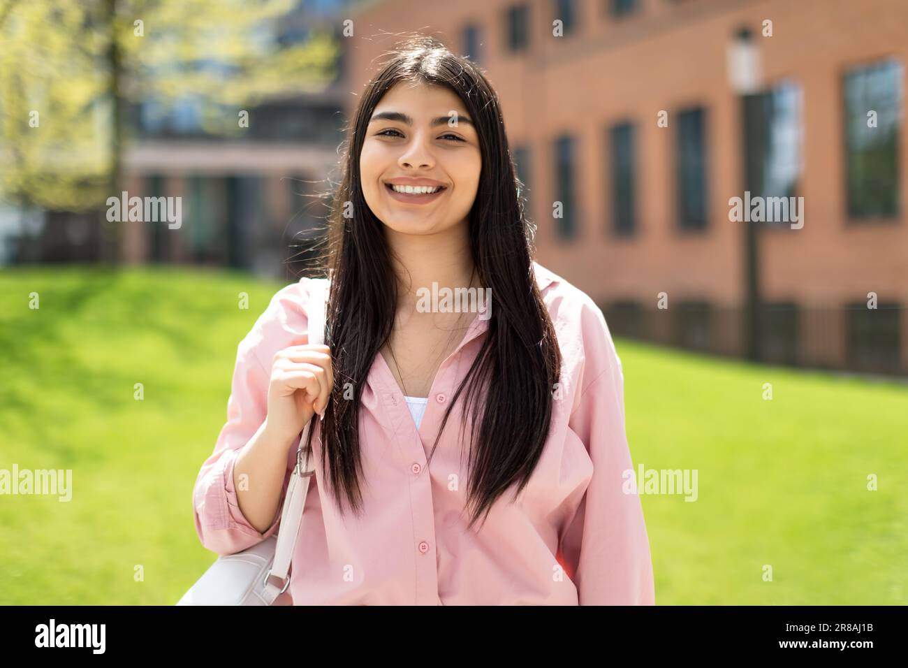 Portrait of cheerful hispanic lady student with backpack ready for ...