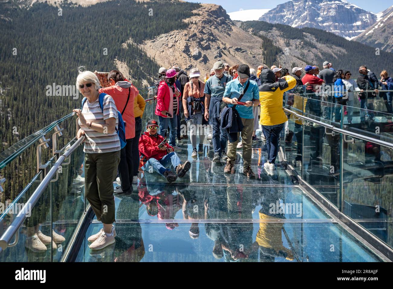 Tourists standing on the glass floored observation deck of the Columbia ...