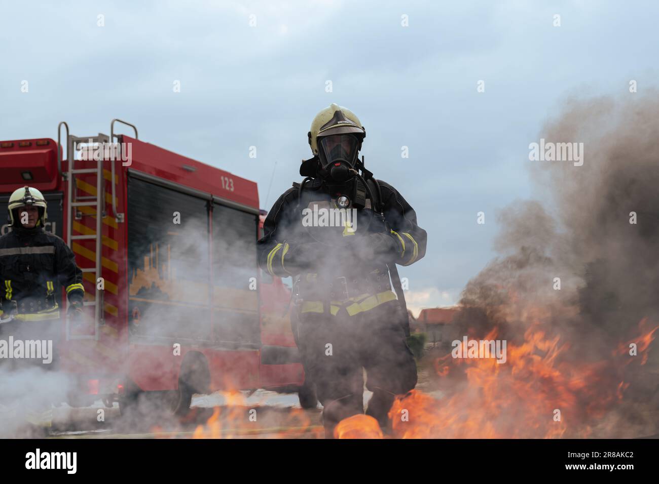 Firefighters using water fog type fire extinguisher to fighting with ...
