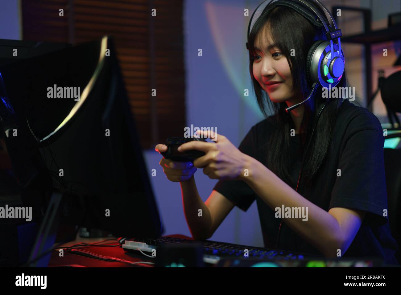 Female cyber hacker gamer using controller joystick to playing or ...