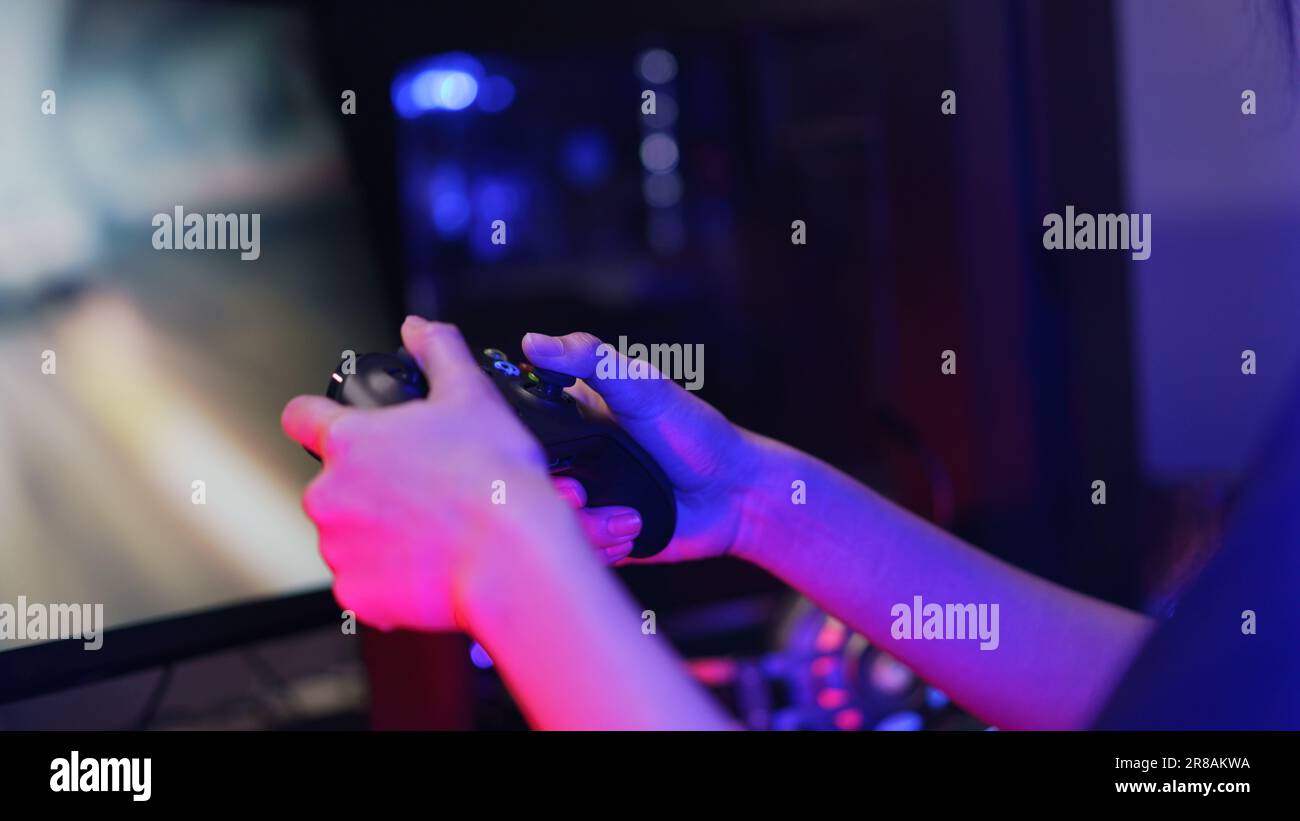 Hand of female cyber hacker gamer holding controller joystick to ...