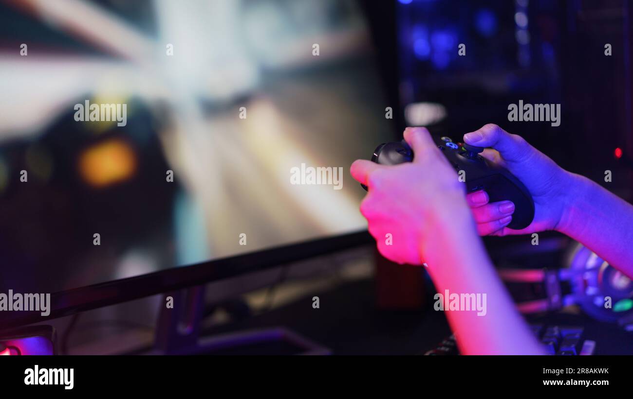Hand of female cyber hacker gamer holding controller joystick to ...