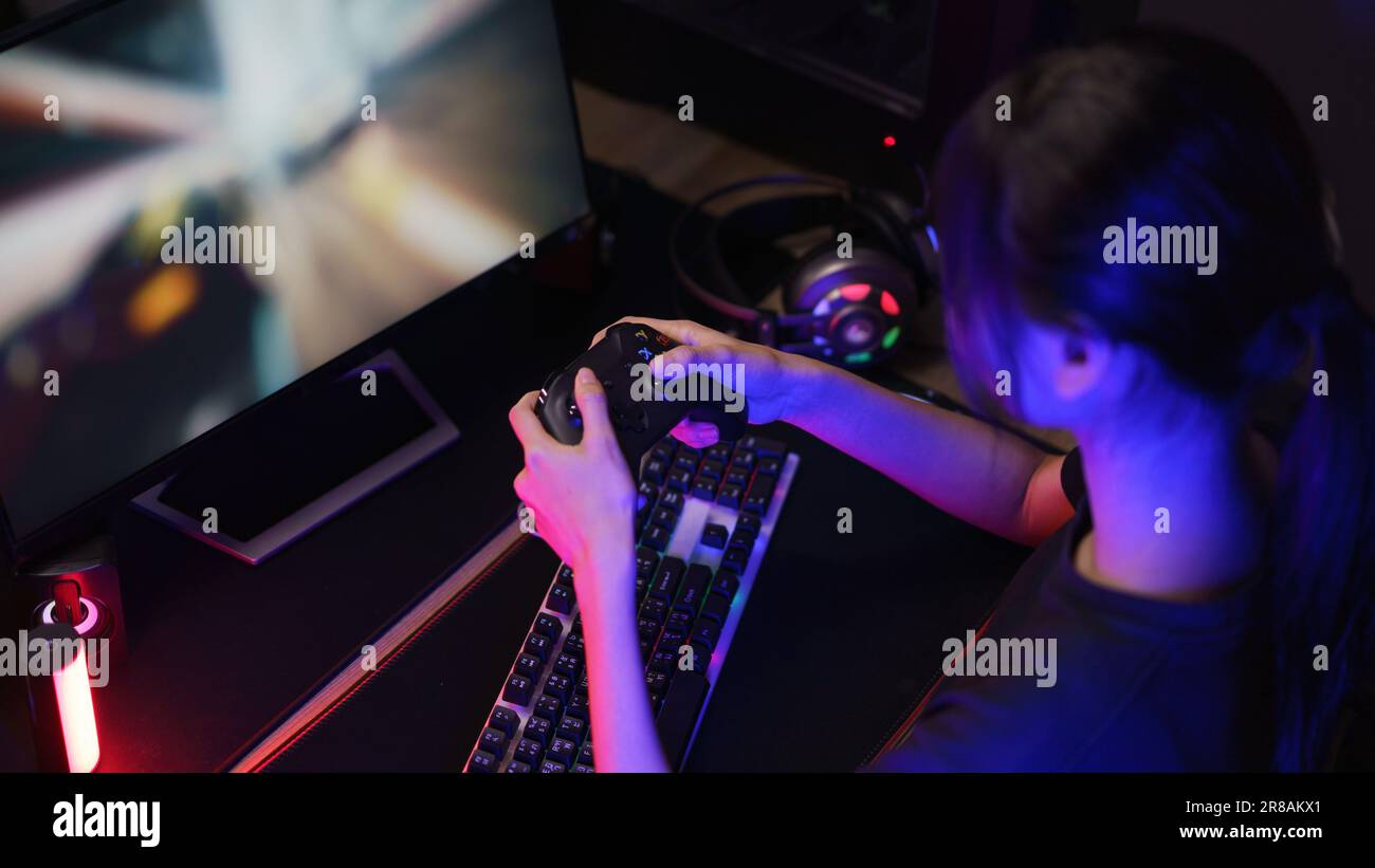 Female cyber hacker gamer playing or streaming video games on computer ...