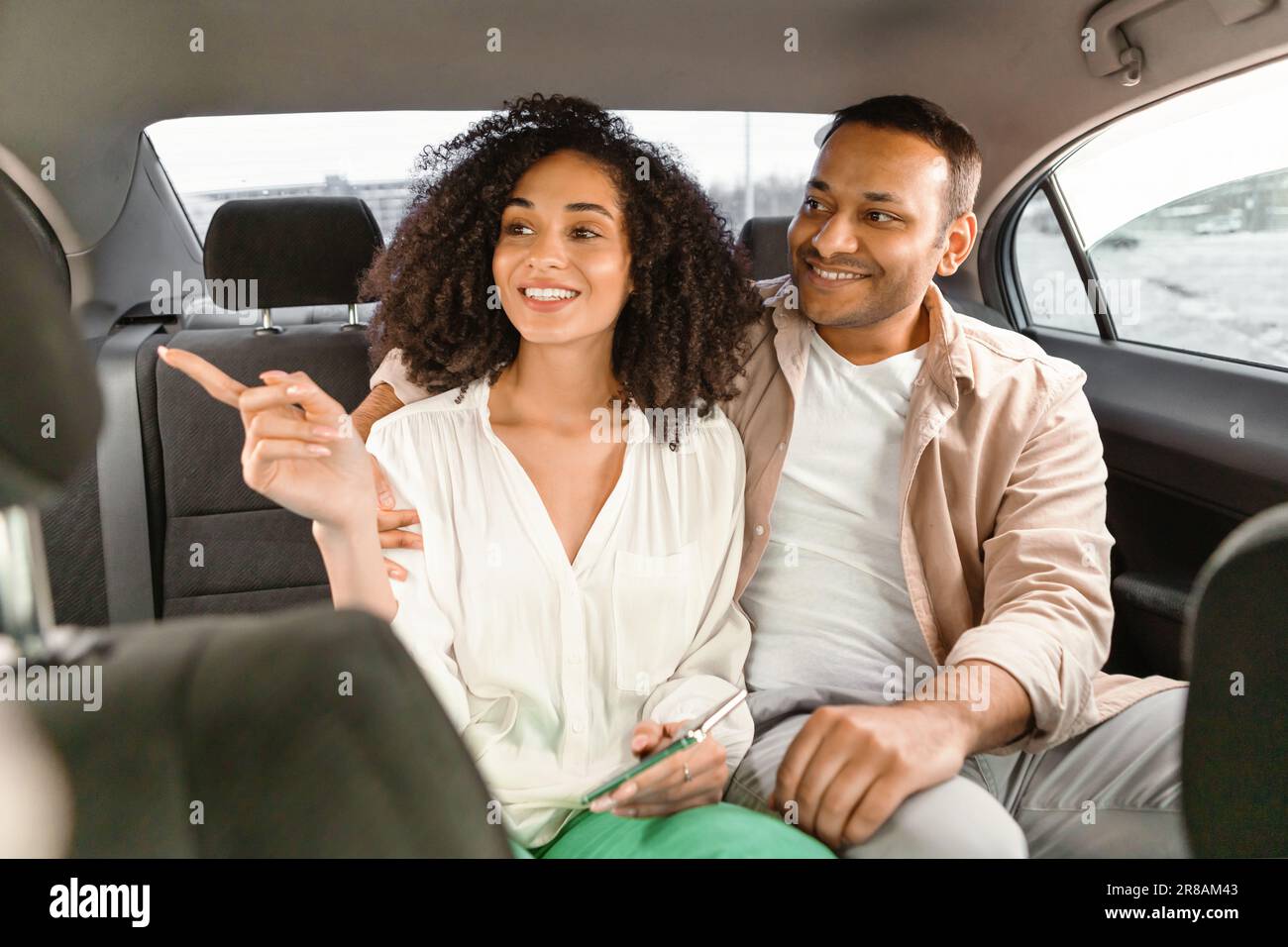 Lady Pointing While Sitting With Husband On Backseat Of Auto Stock
